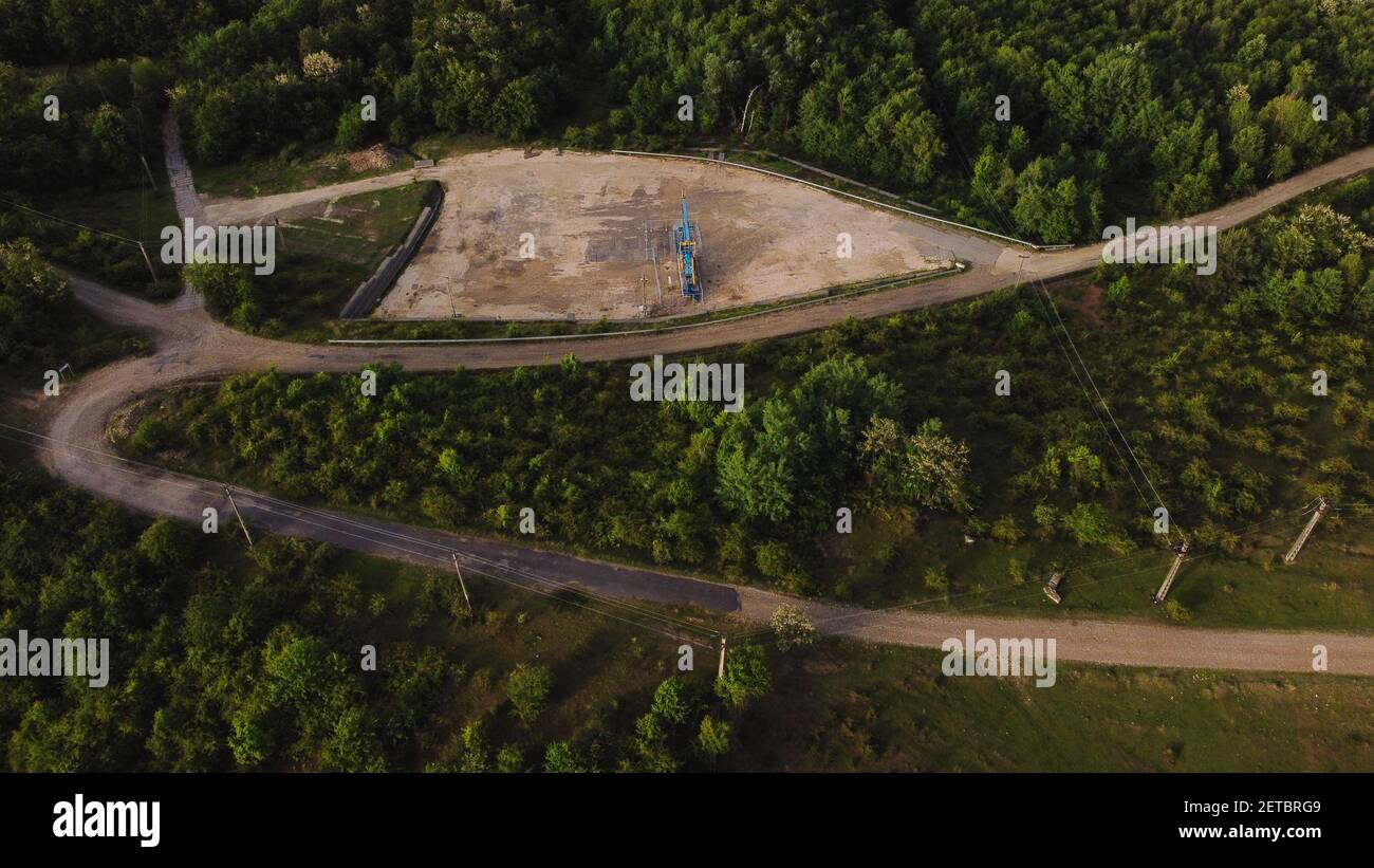 An aerial view of countryside land with dense vegetation and roads ...