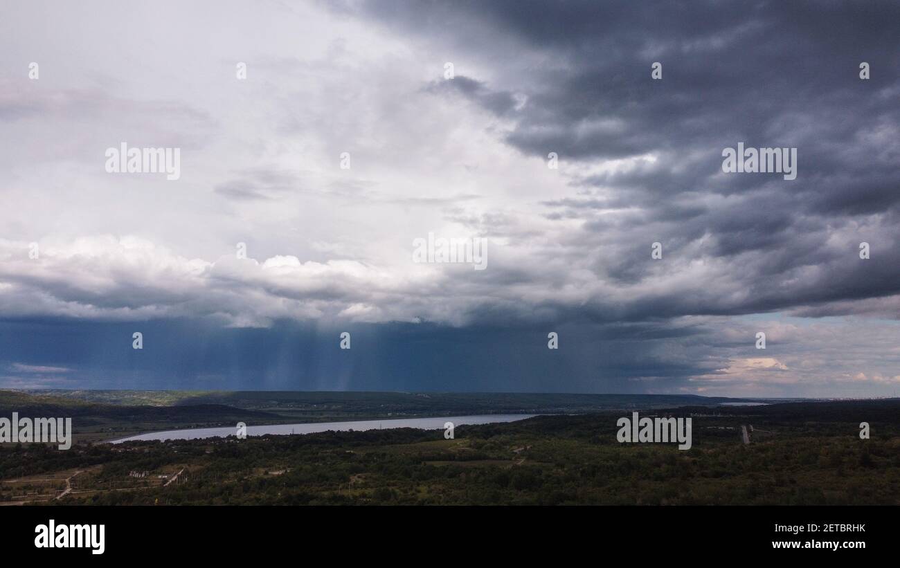 A beautiful view of calm lake water and a grassy shoreline under a ...
