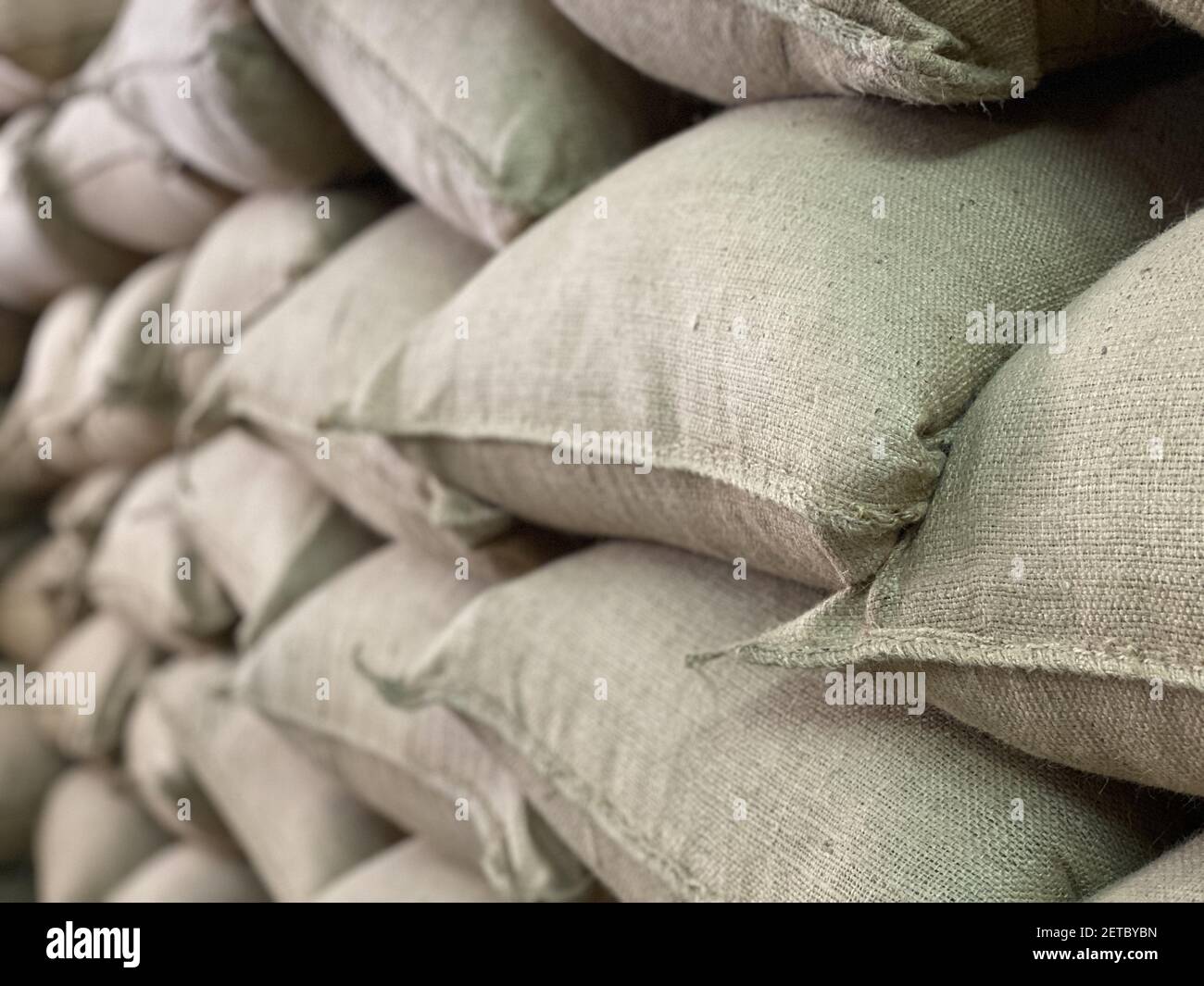 A closeup view of various cement bags placed on top of one another ...