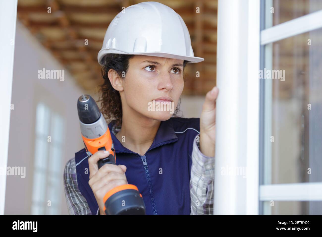 construction worker drilling a window Stock Photo - Alamy