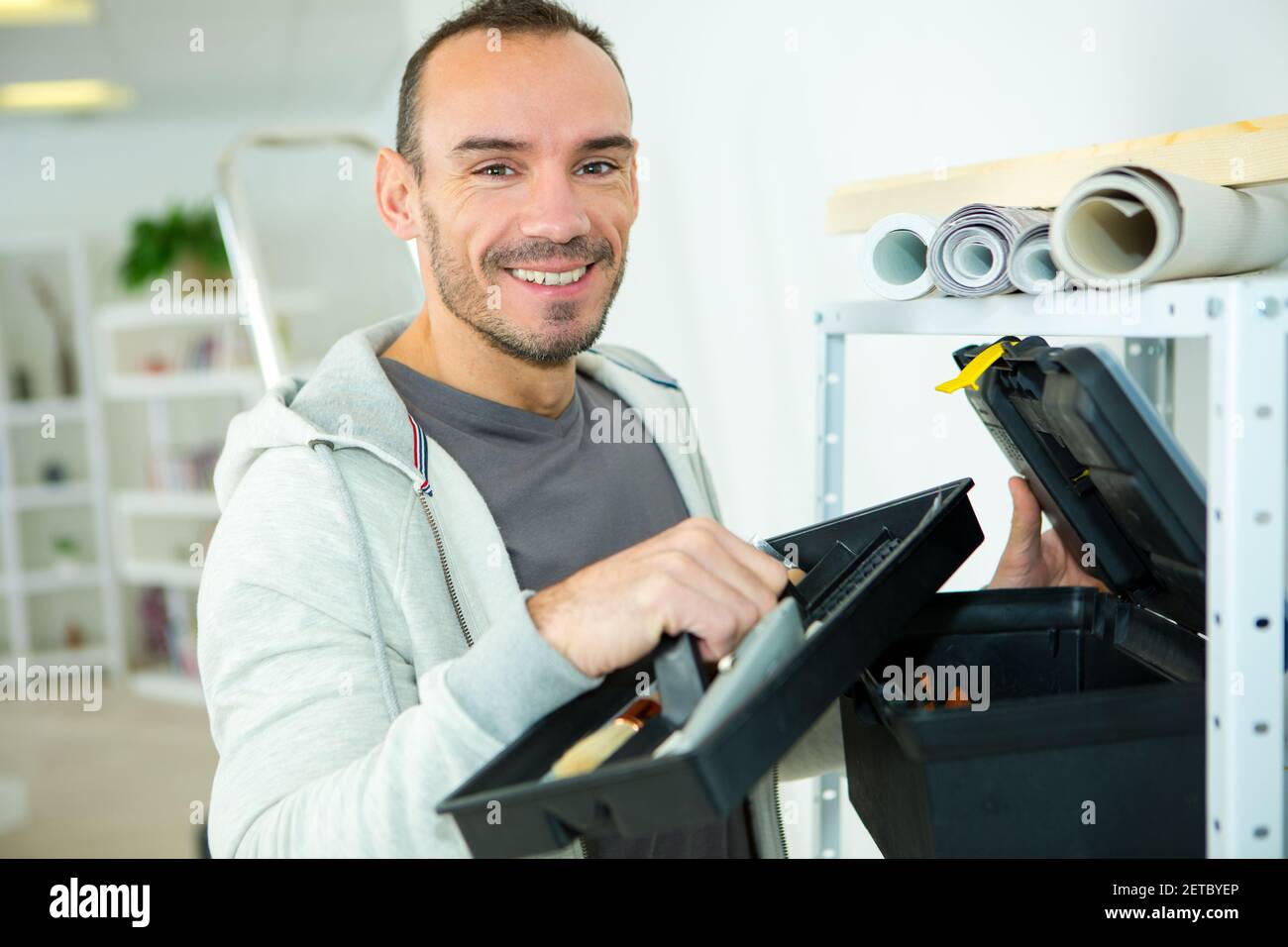 man taking something out from a toolbox Stock Photo - Alamy
