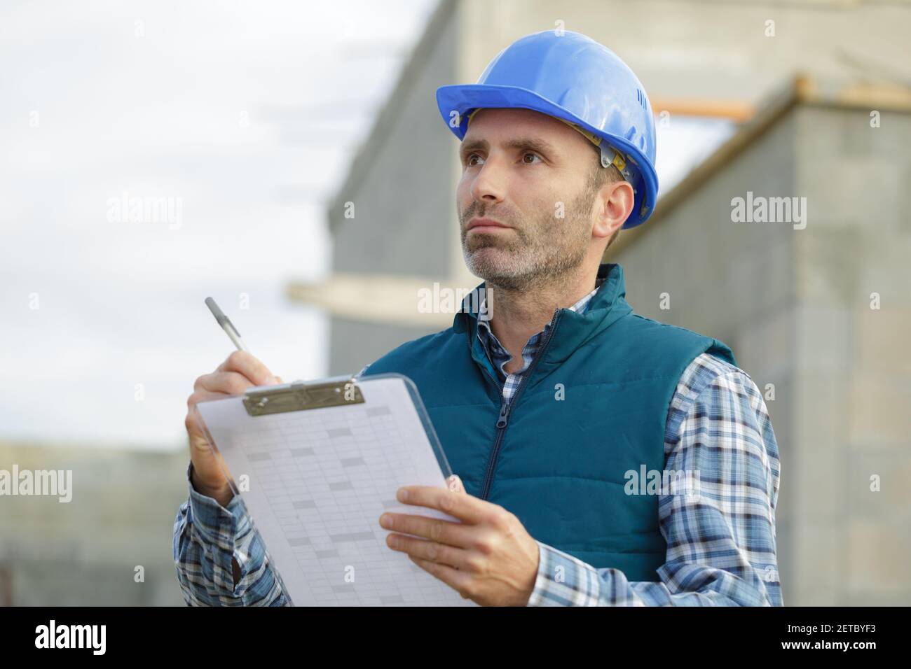 construction manager writing report at construction site Stock Photo ...