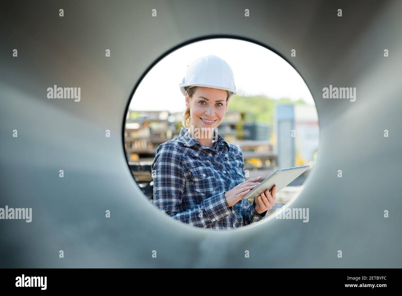 woman looking through a pipe Stock Photo - Alamy