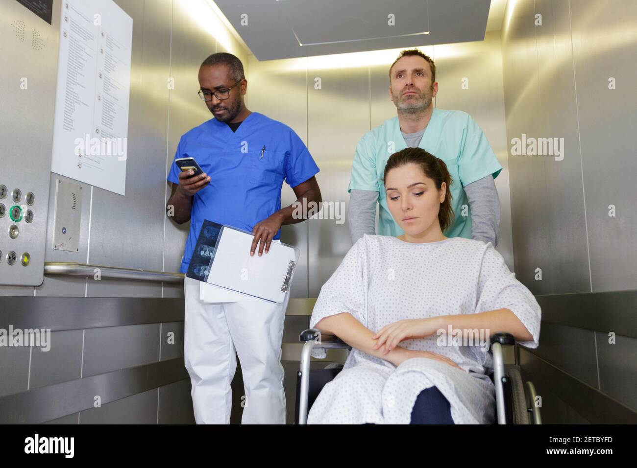 woman sitting in wheelchair in the elevator Stock Photo - Alamy