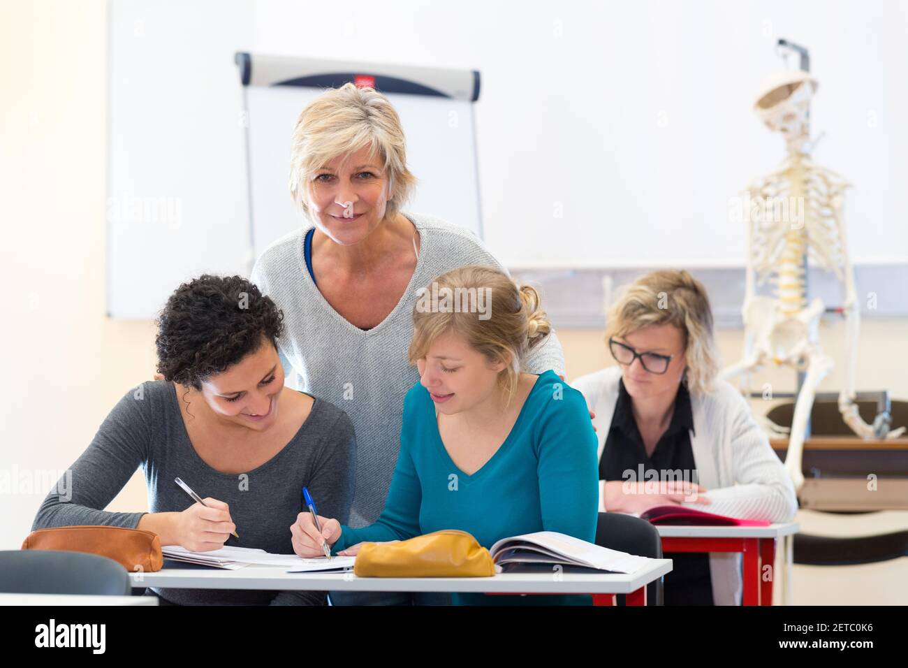 science class with a teacher and three female students Stock Photo - Alamy