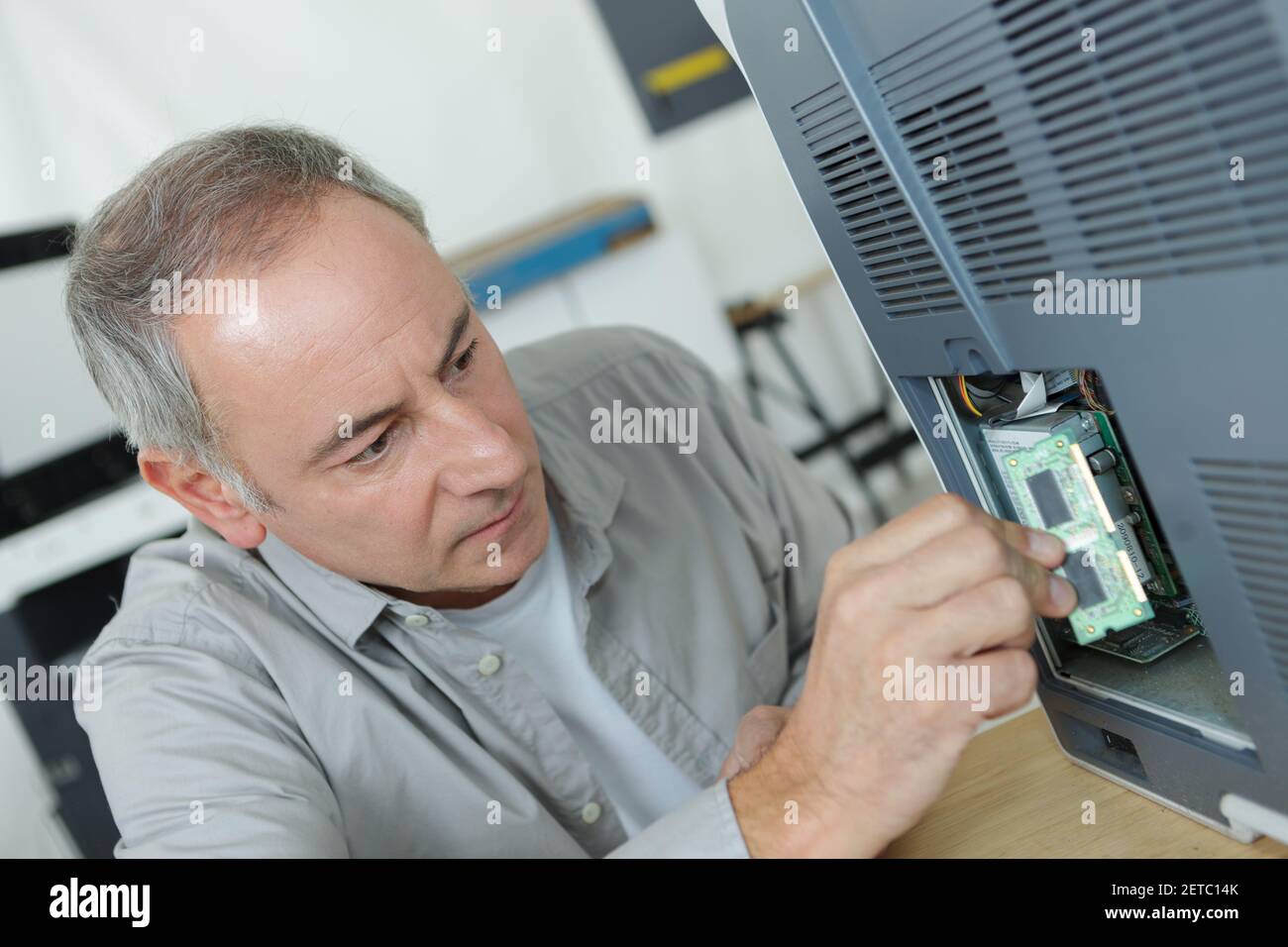 a man fixing a printer Stock Photo - Alamy