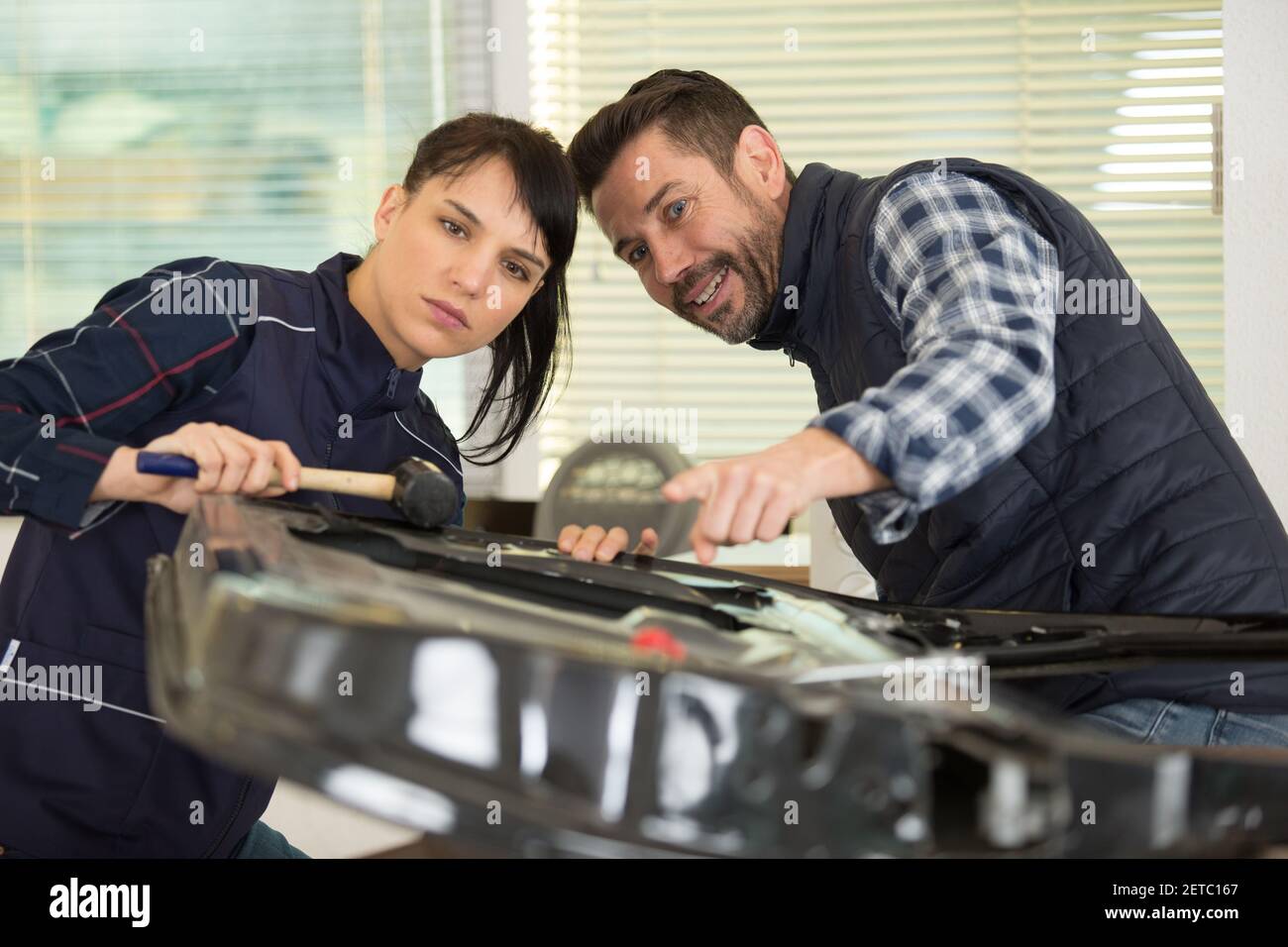 portrait of two professional mechanics near car workshop Stock Photo ...