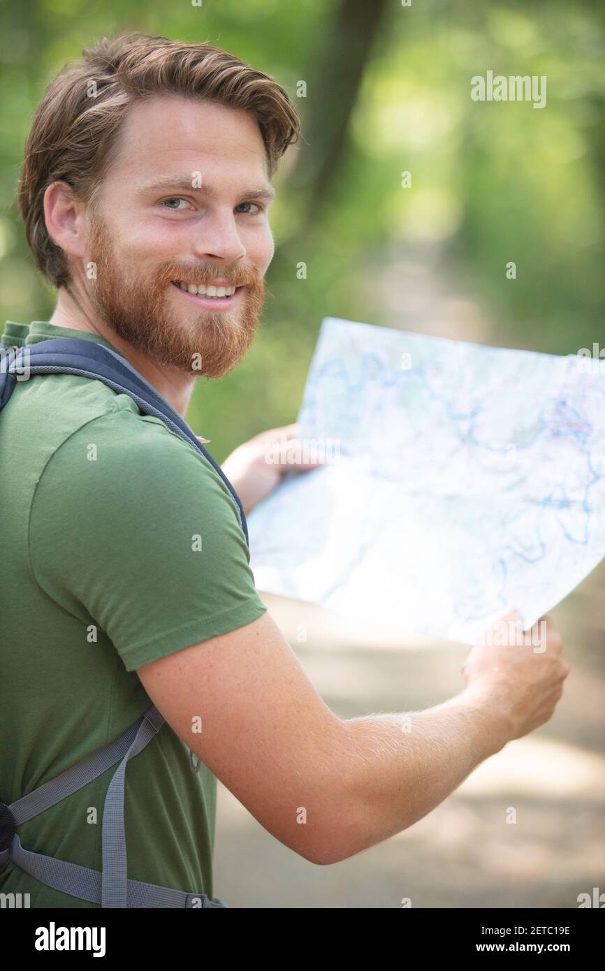 male traveler sat holding map Stock Photo - Alamy