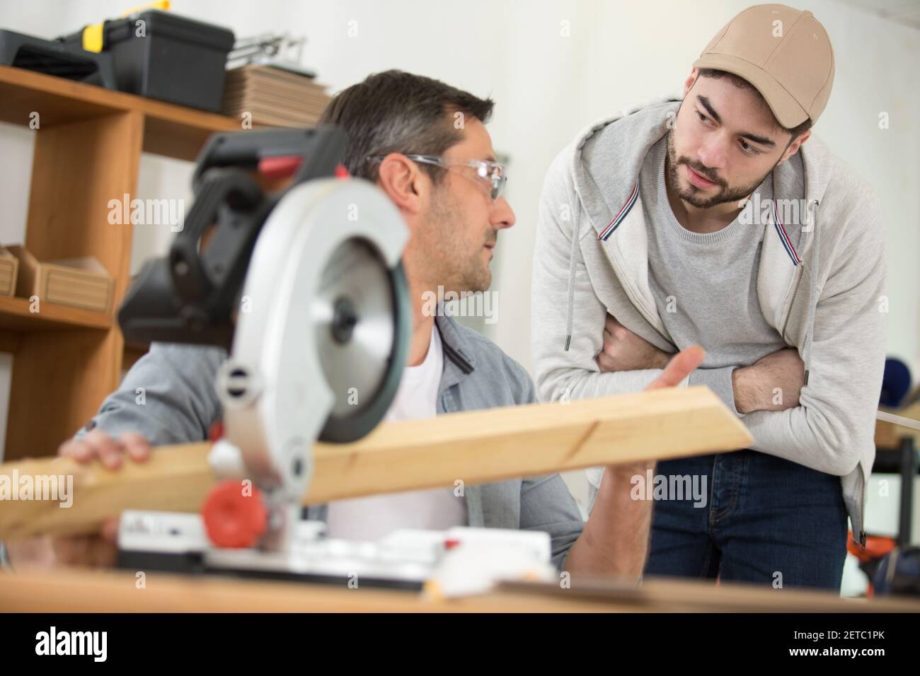 student and teacher in carpentry class using circular saw Stock Photo ...