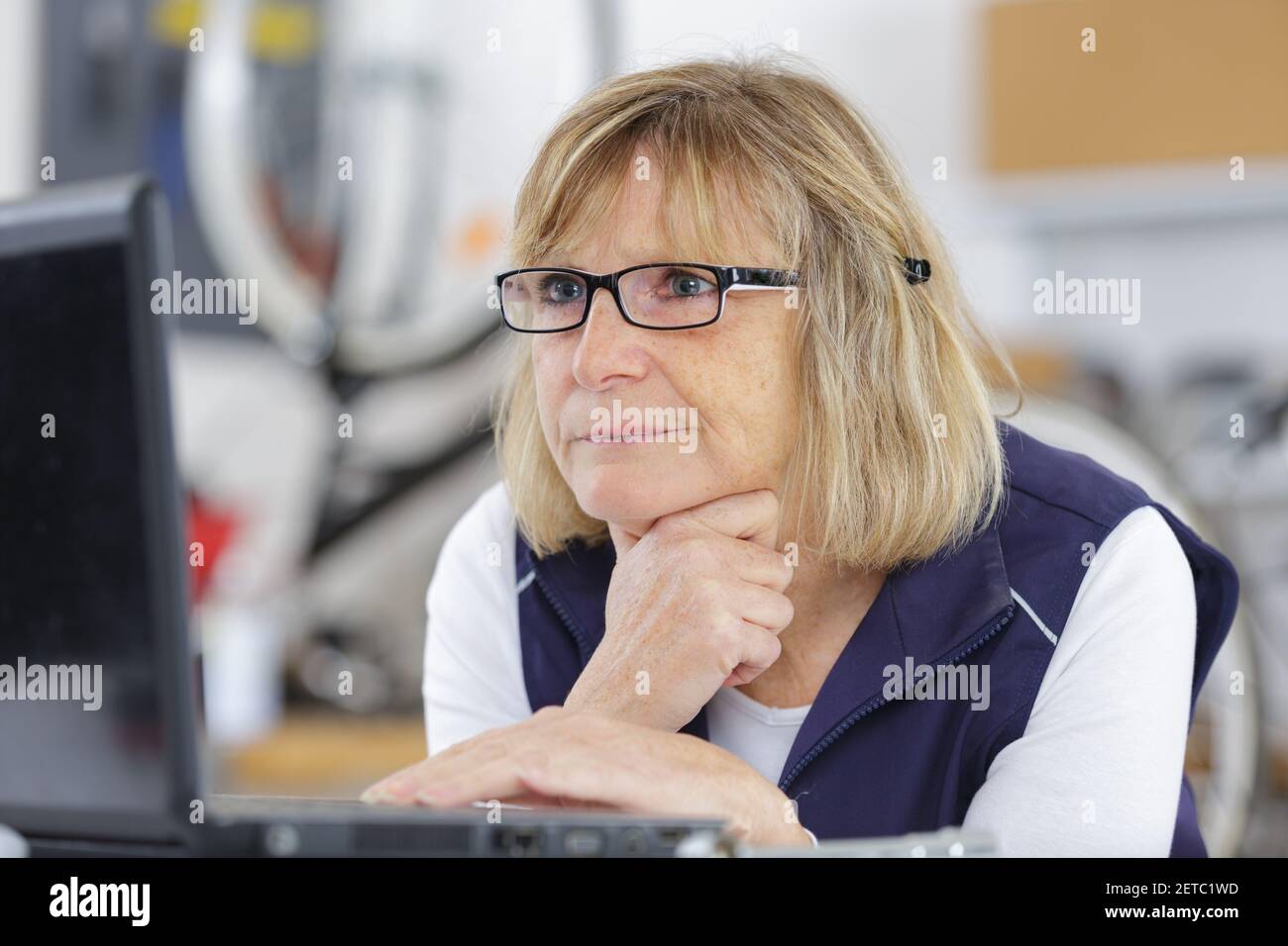 small business owner using computer in a store Stock Photo - Alamy