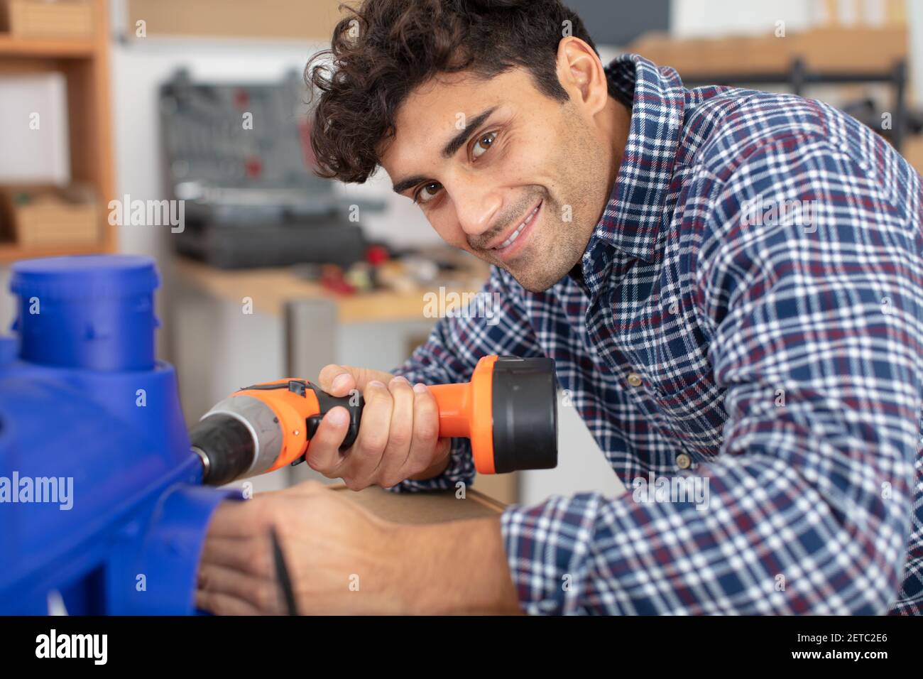 young handsome man repairing hardware Stock Photo - Alamy