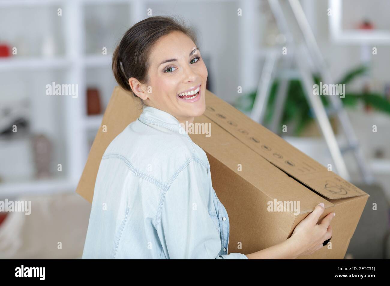 young woman with boxes - move concept Stock Photo - Alamy
