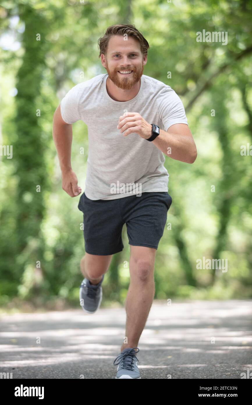 sport and fitness runner man running on road Stock Photo - Alamy