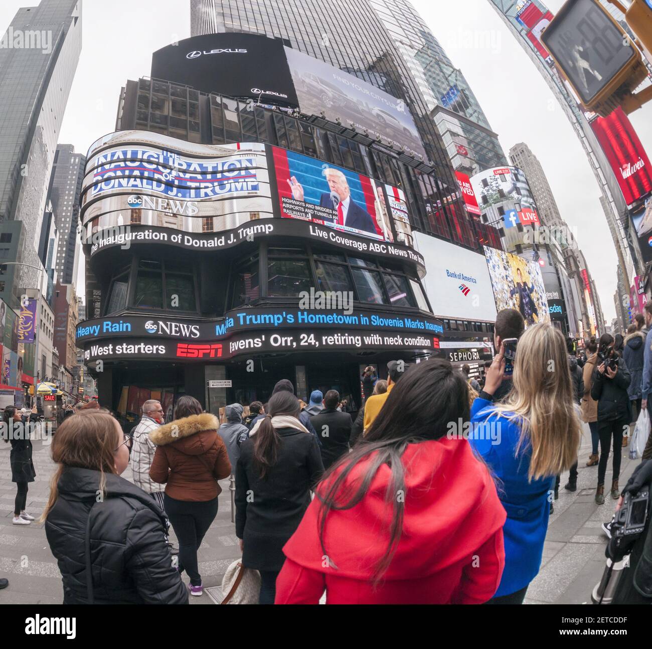 Visitors to Times Square in New York view the inauguration of Donald ...