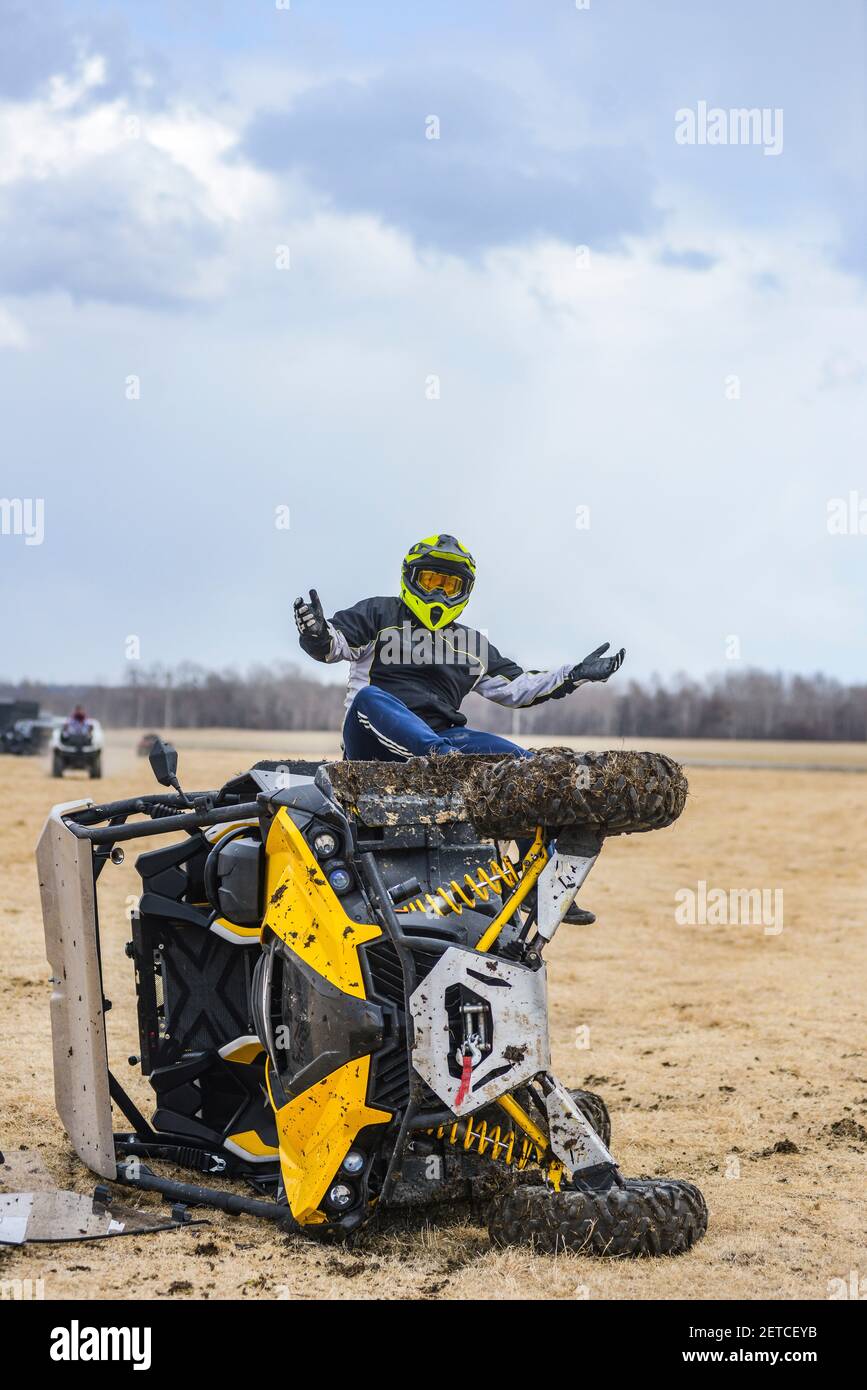 ATV UTV overturned, the rider sits near the broken all-terrain vehicle ...