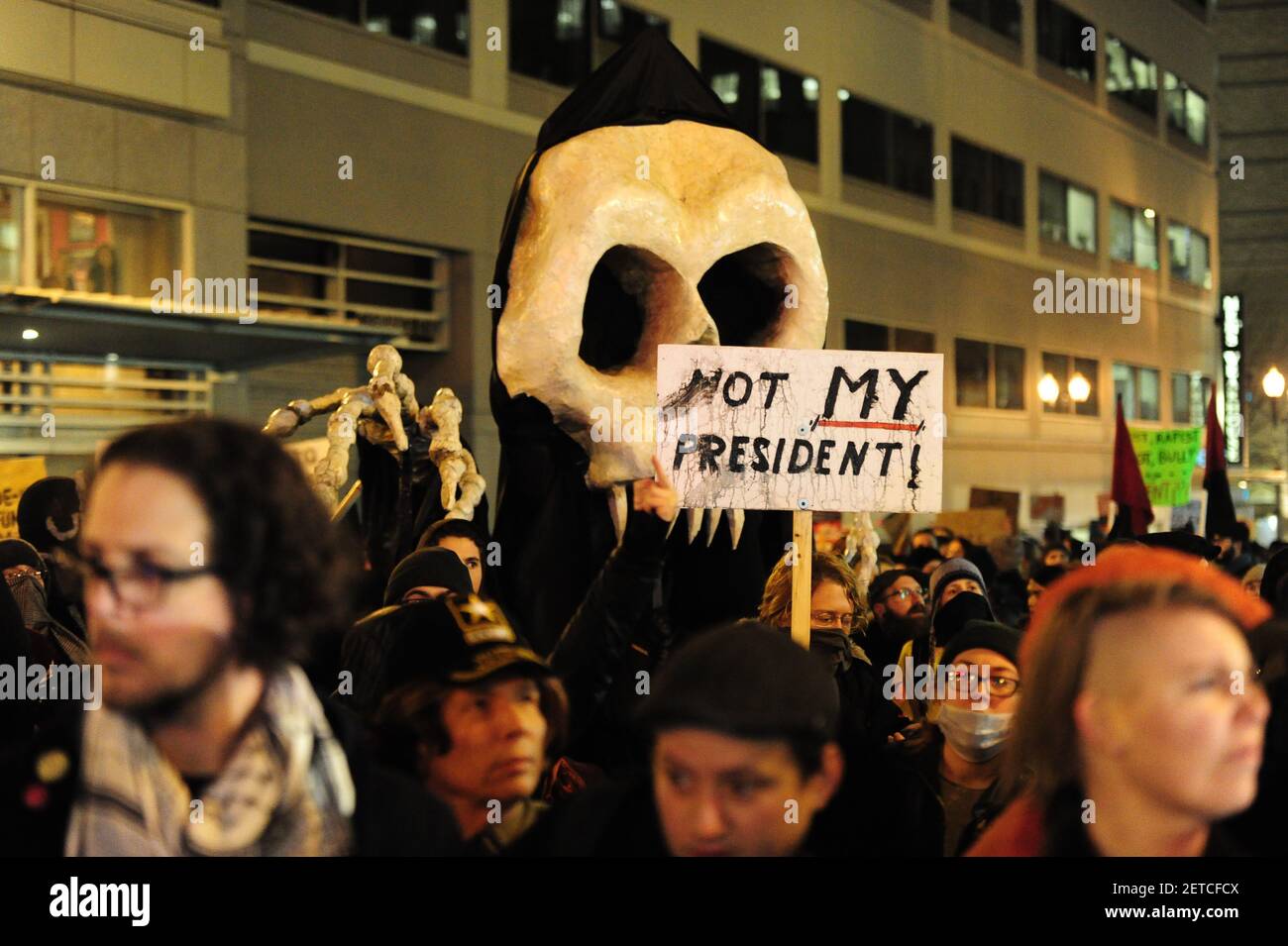 Protesters carry a giant grim reaper in Portland, Ore., on January 20 ...
