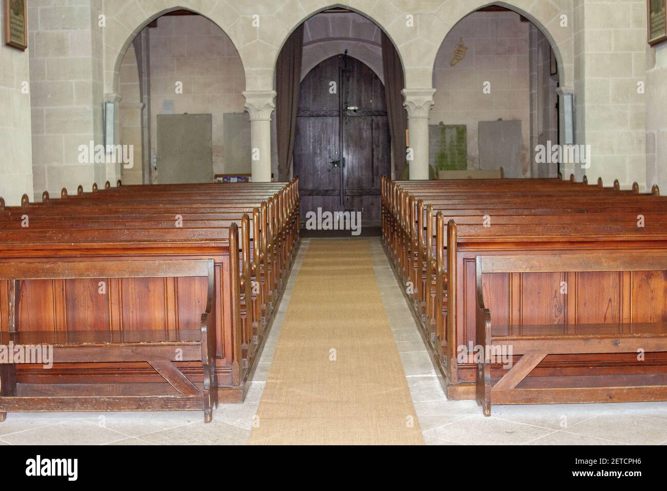 An aged church interior with chairs on background of a medieval wooden ...