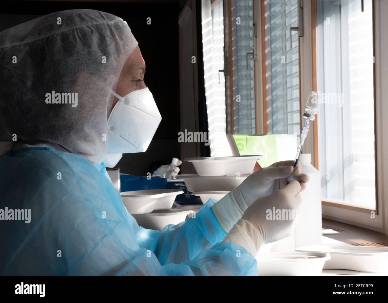 Medical worker prepare an injection of vaccine during a massive ...
