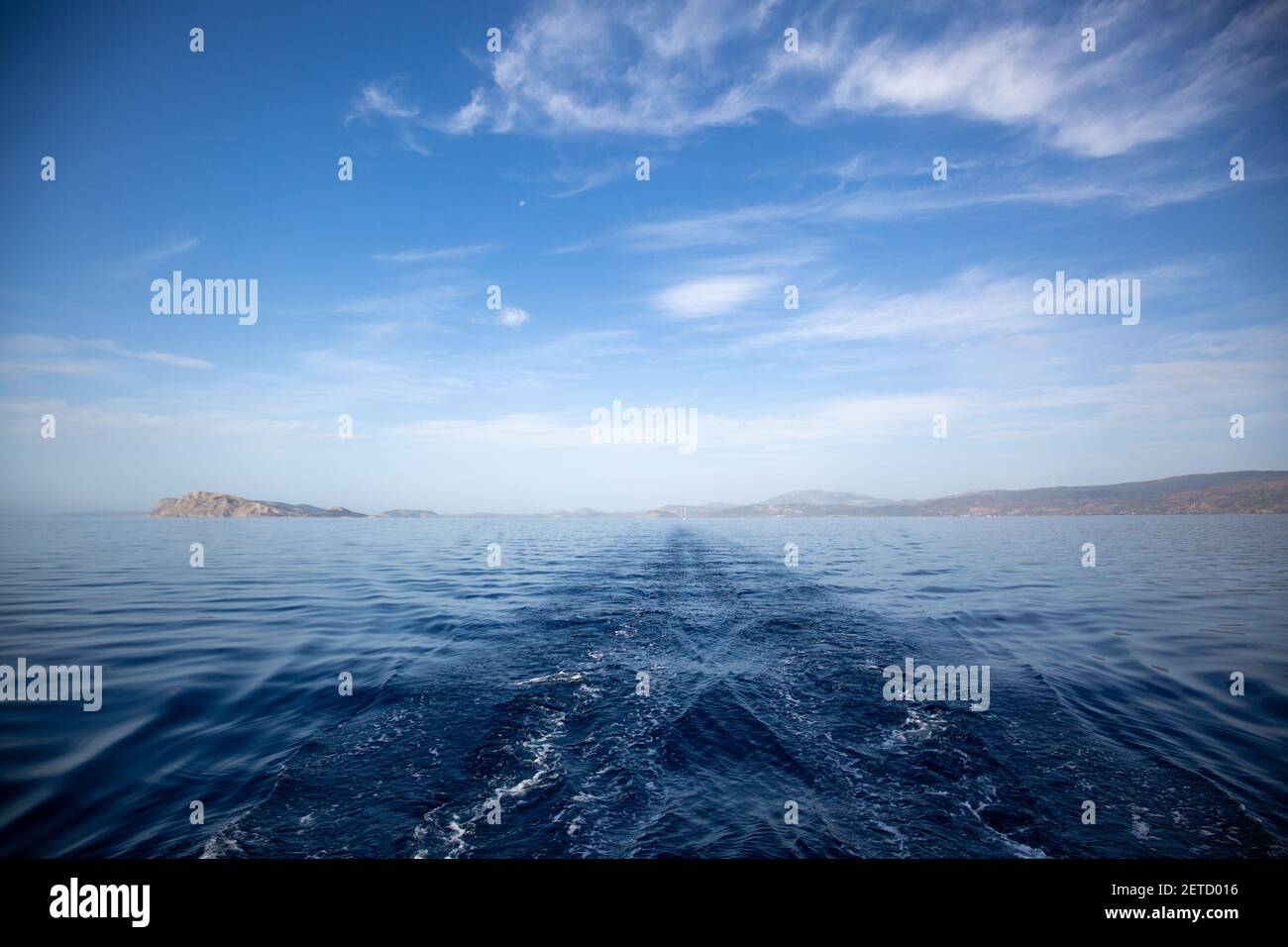 A beautiful shot of deep blue sea waters with ship track under the blue ...