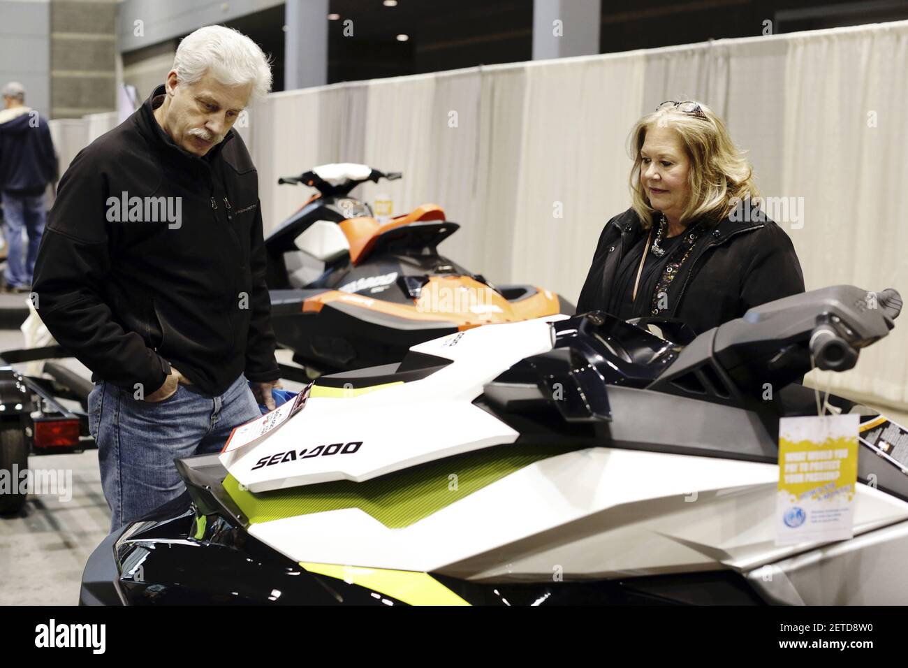 Steve, left, and Kim Heeter, right, look at a Sea-Doo personal ...