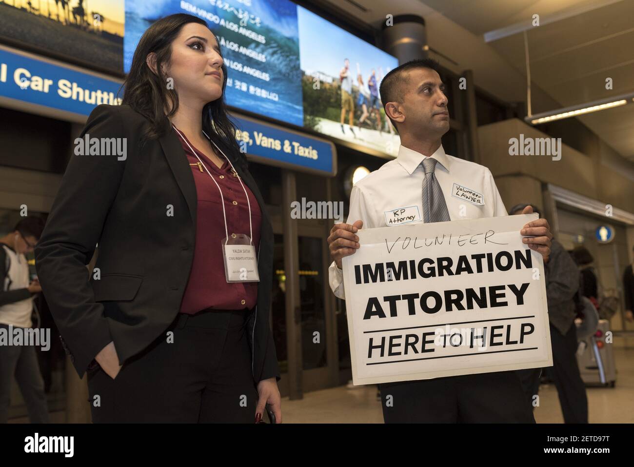 Volunteer attorneys, Yalda Satar (L) and Kapesh Patel stationed at Los ...
