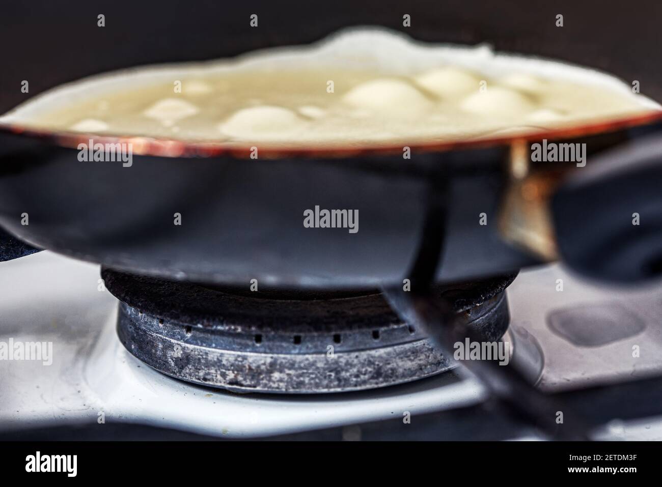 Frying pan on a gas stove in the kitchen Stock Photo - Alamy
