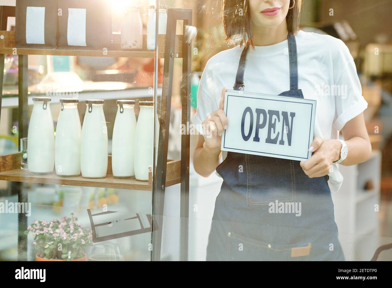 Store owner holding open sign Stock Photo - Alamy