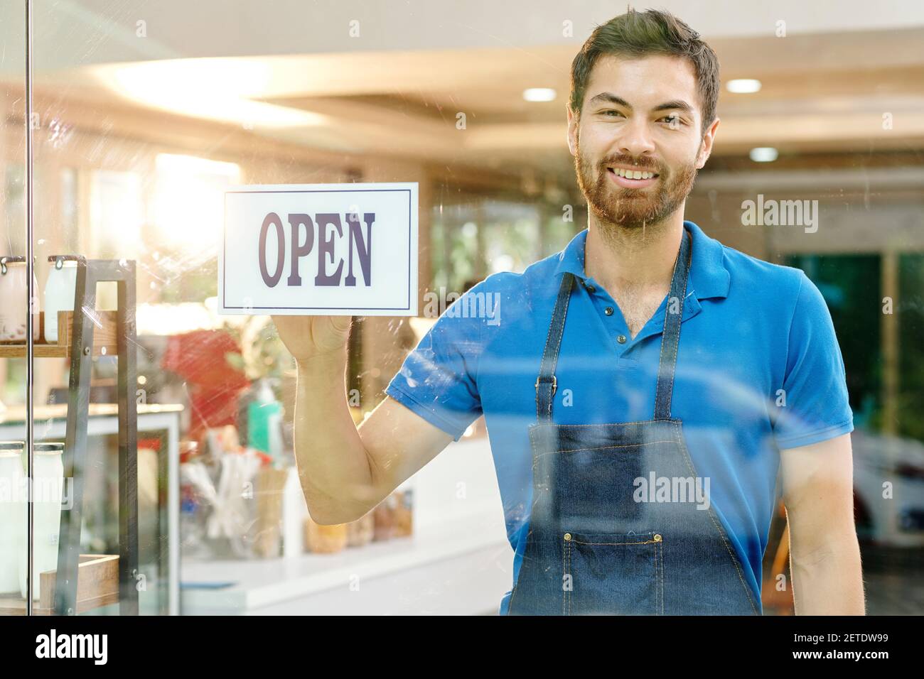 Barista opening cafe Stock Photo - Alamy