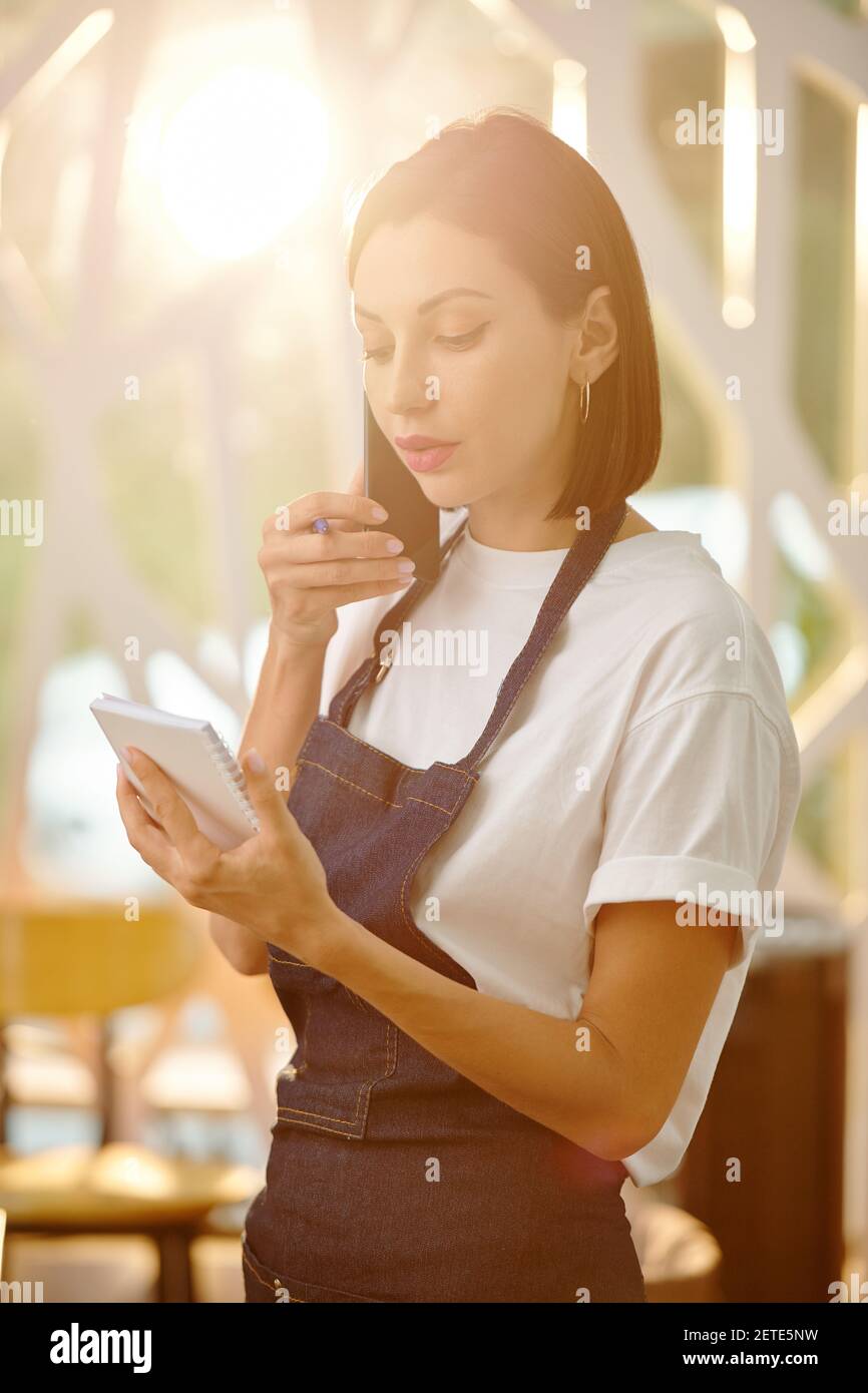 Waitress calling customer Stock Photo - Alamy