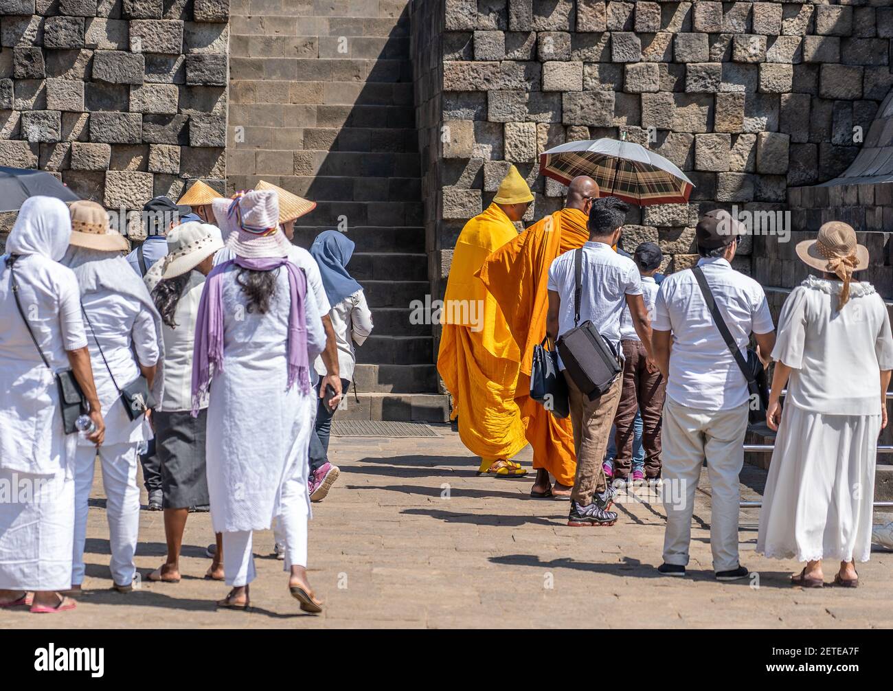 BOROBUDUR, INDONESIA - Jul 10, 2019: People and monks visiting ... BOROBUDUR, INDONESIA - Jul 10, 2019: People and monks visiting ...