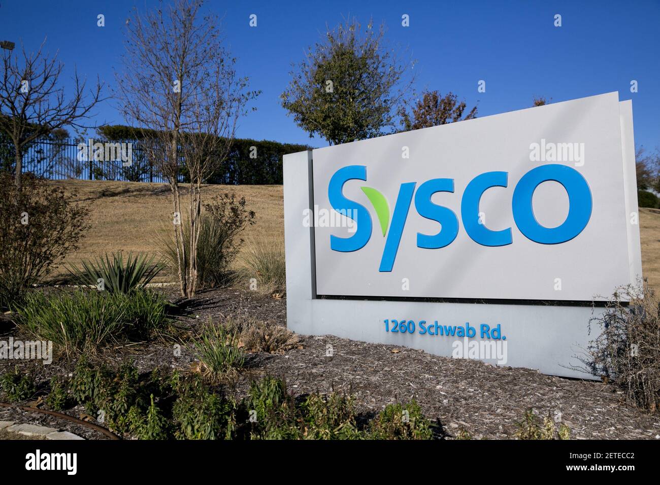 A logo sign outside of a facility occupied by the Sysco Corporation in ...