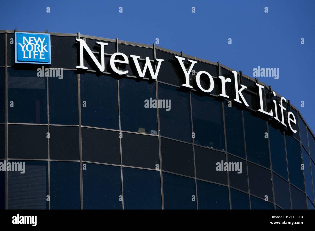 A logo sign outside of a facility occupied by the New York Life ...