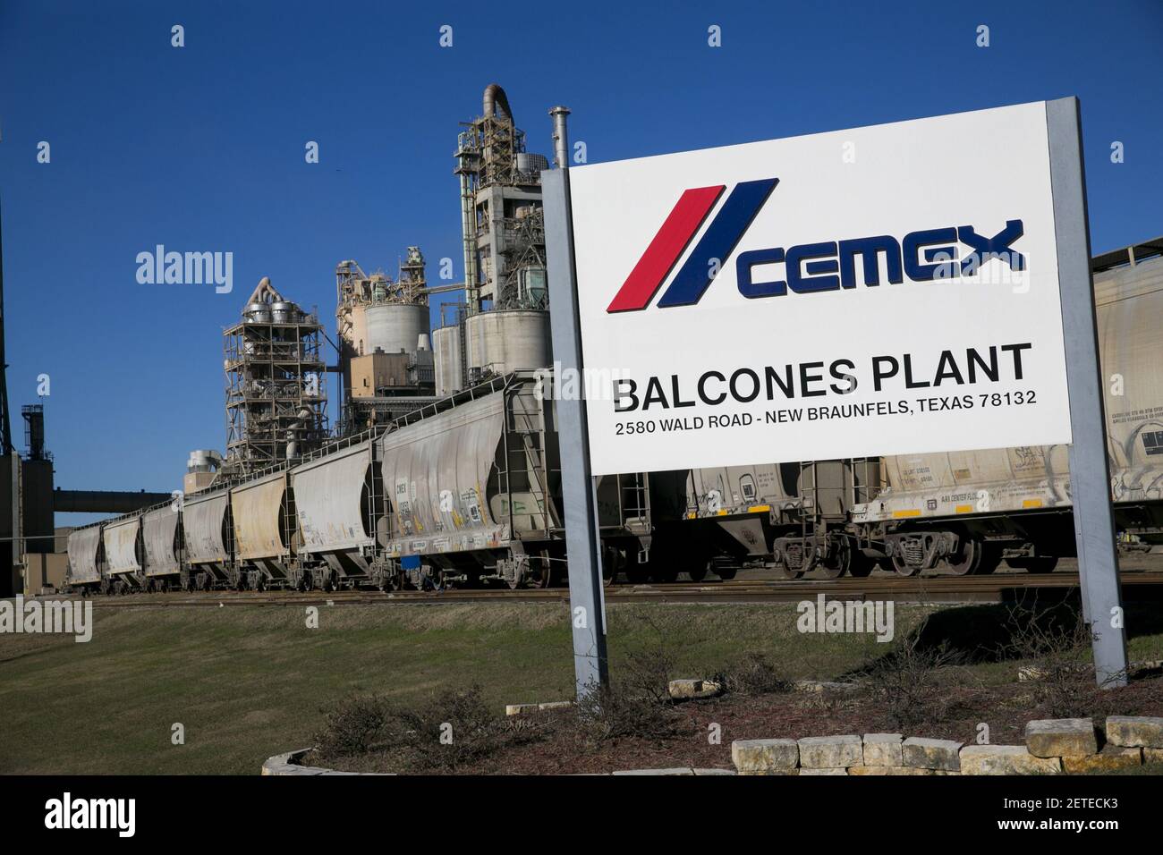 A logo sign outside of a facility occupied by Cemex in New Braunfels ...