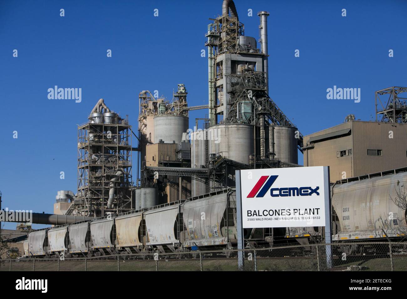 A logo sign outside of a facility occupied by Cemex in New Braunfels ...