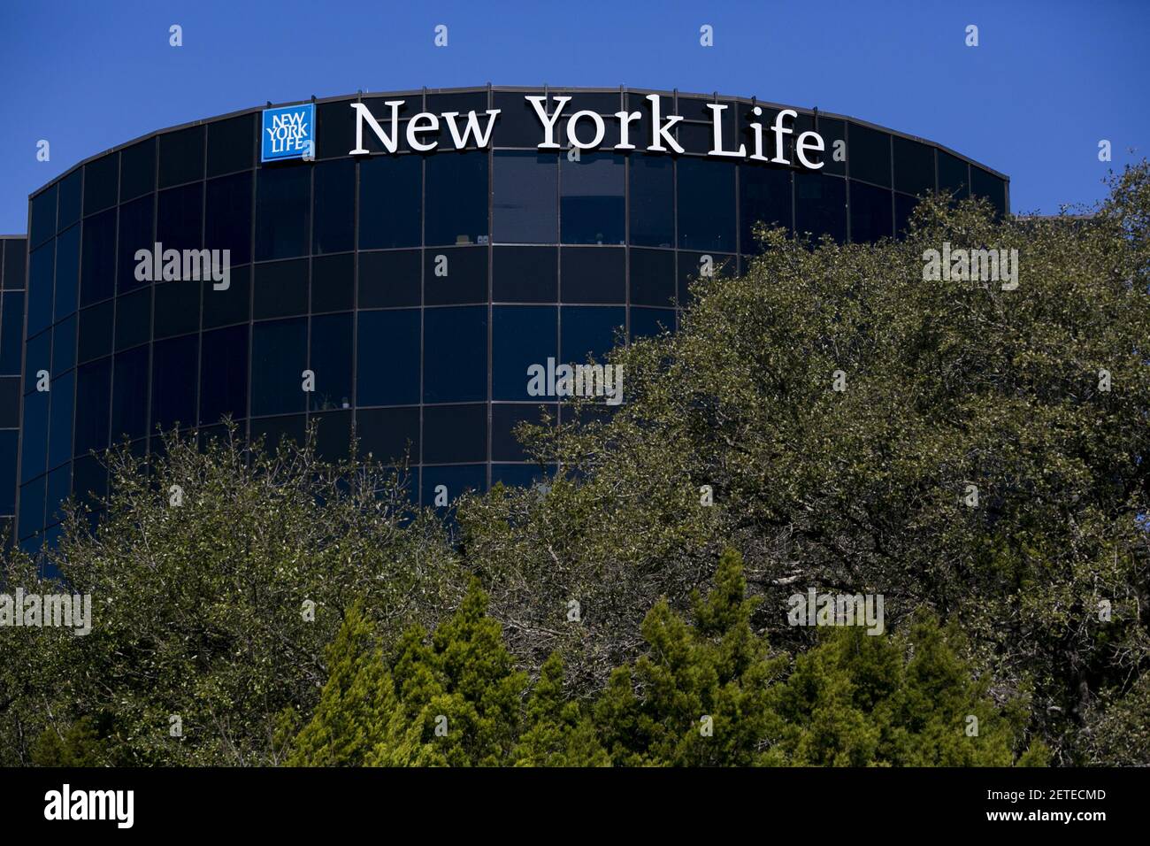 A logo sign outside of a facility occupied by the New York Life ...