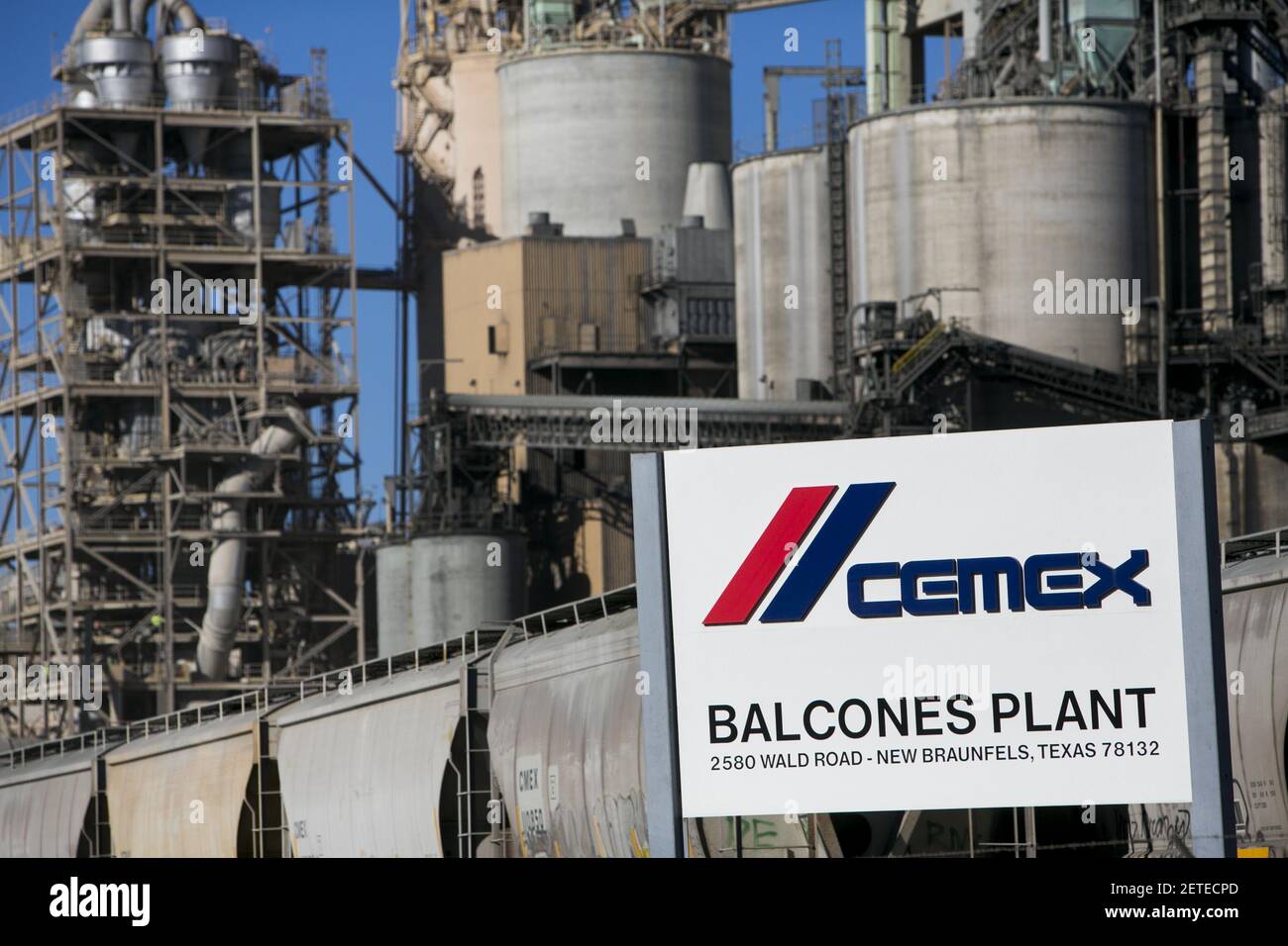 A logo sign outside of a facility occupied by Cemex in New Braunfels ...