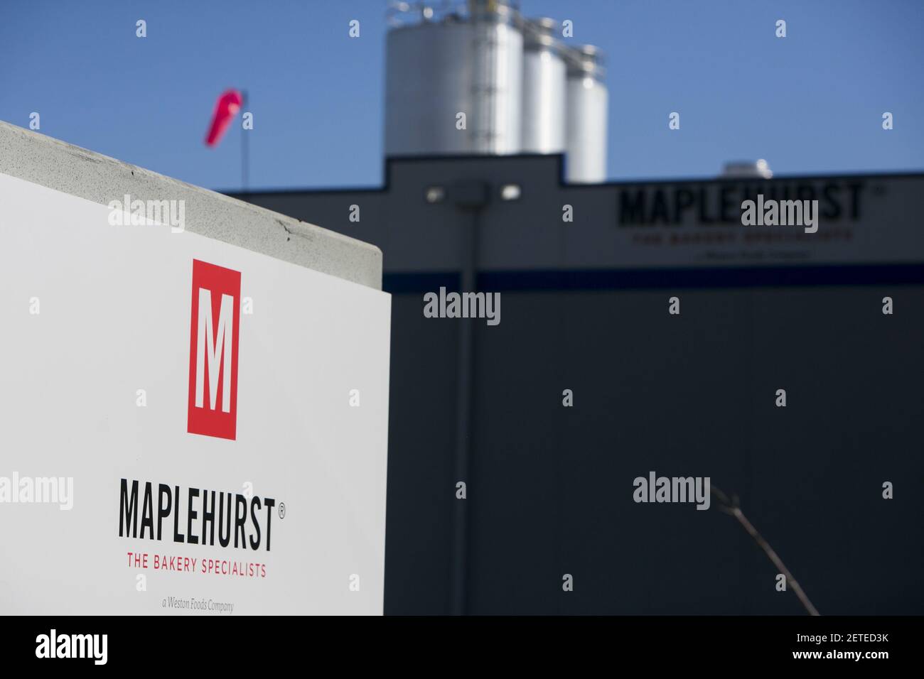 A logo sign outside of a facility occupied by Maplehurst Bakeries in ...