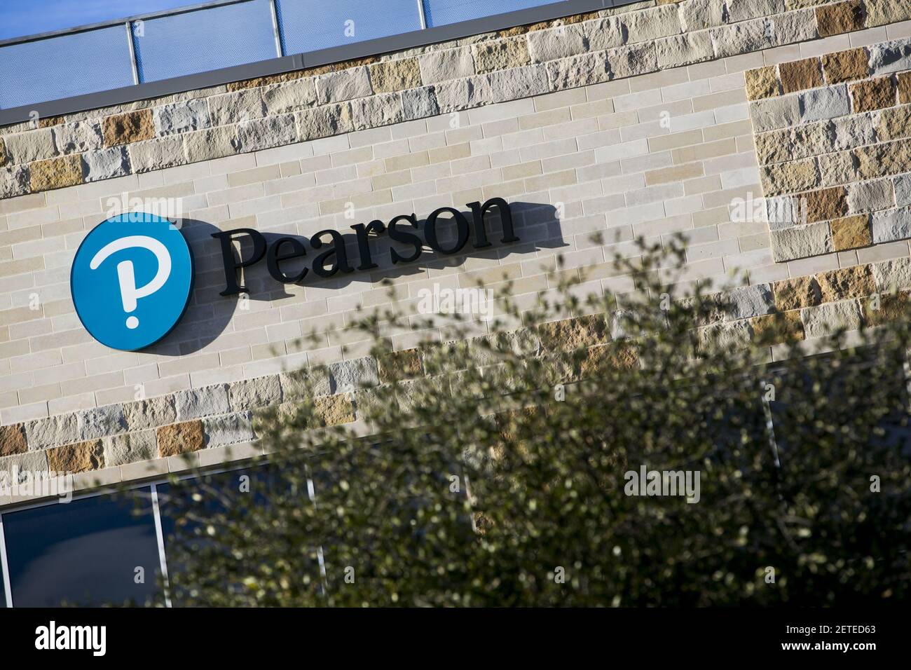 A logo sign outside of a facility occupied by Pearson PLC in Austin ...