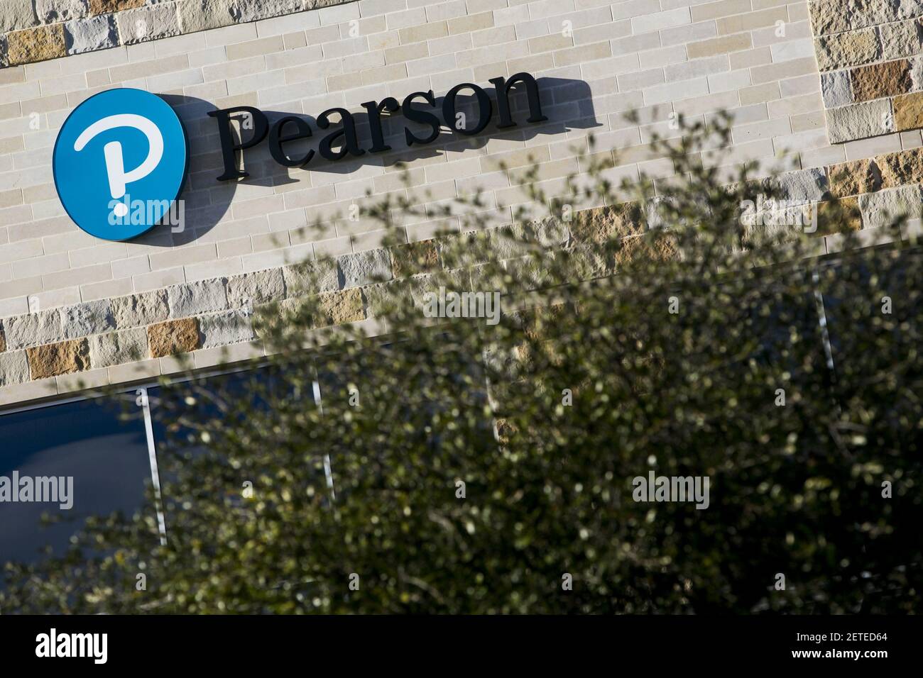 A logo sign outside of a facility occupied by Pearson PLC in Austin ...