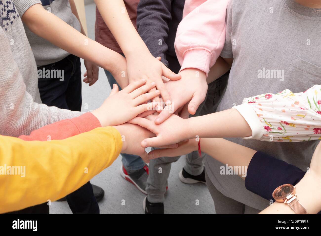 Teamwork hands children together hi-res stock photography and images ...