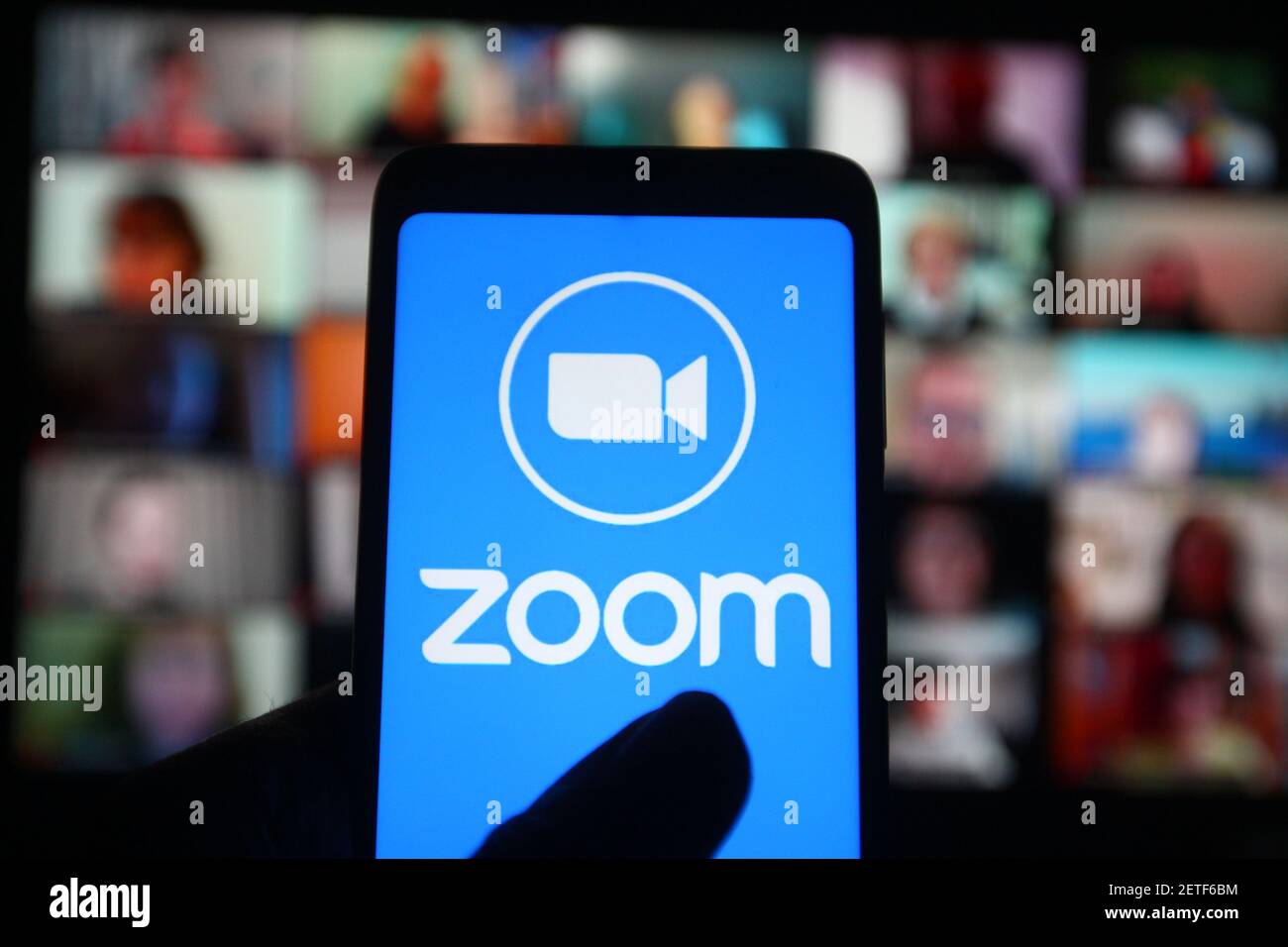 In this photo illustration a Zoom logo of a company that provides video ...
