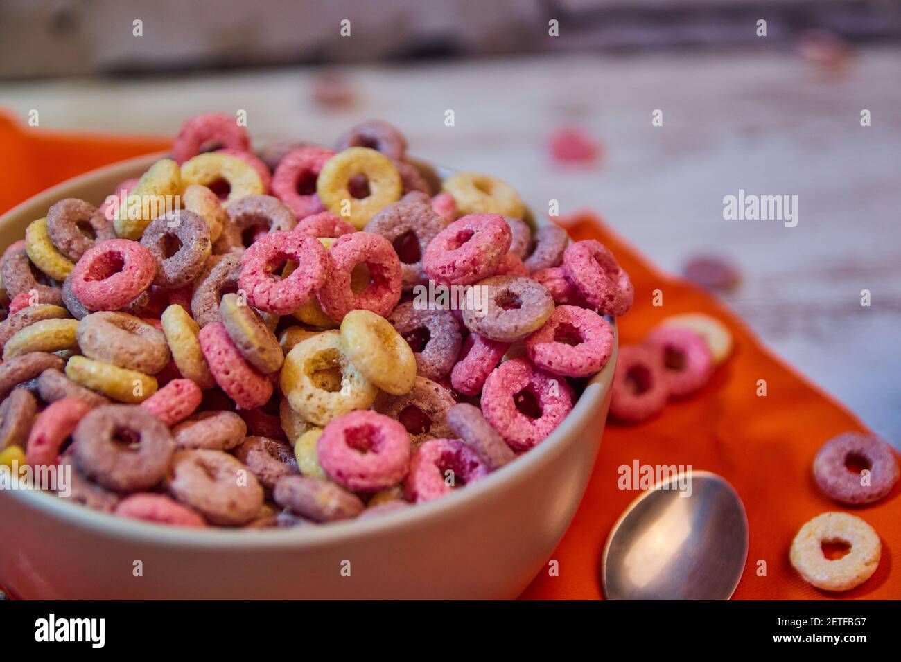 bad breakfast of colorful cereals full of sugar with red fruit juice ...