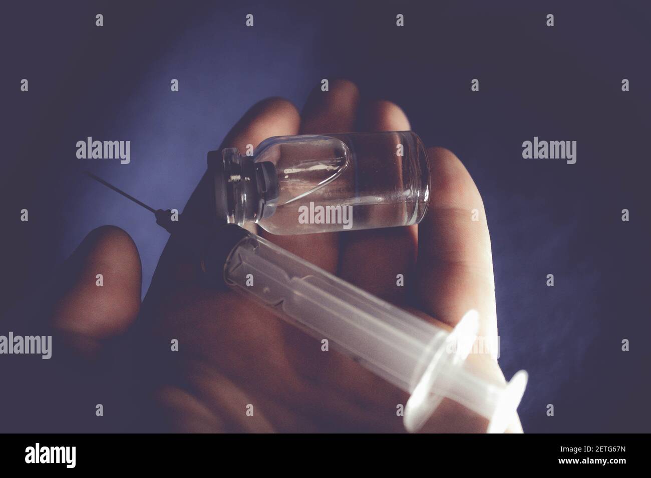 Vaccine in vitro. Medicine in a flask on a blue background. Antibiotic ...