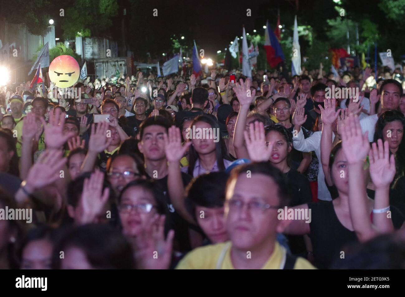 Protesters raise their right hands and recite the Panatang Makabayan ...