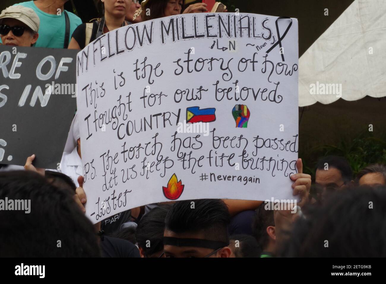 Protesters flash slogans at the People Power Monument in EDSA during ...