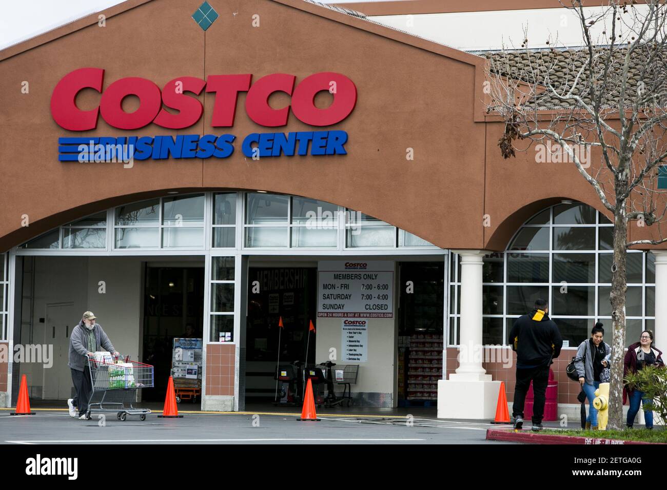 A logo sign outside of a Costco Business Center retail store in Hayward ...