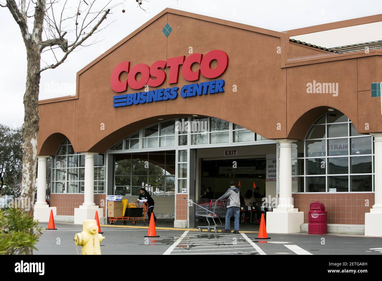 A logo sign outside of a Costco Business Center retail store in Hayward ...