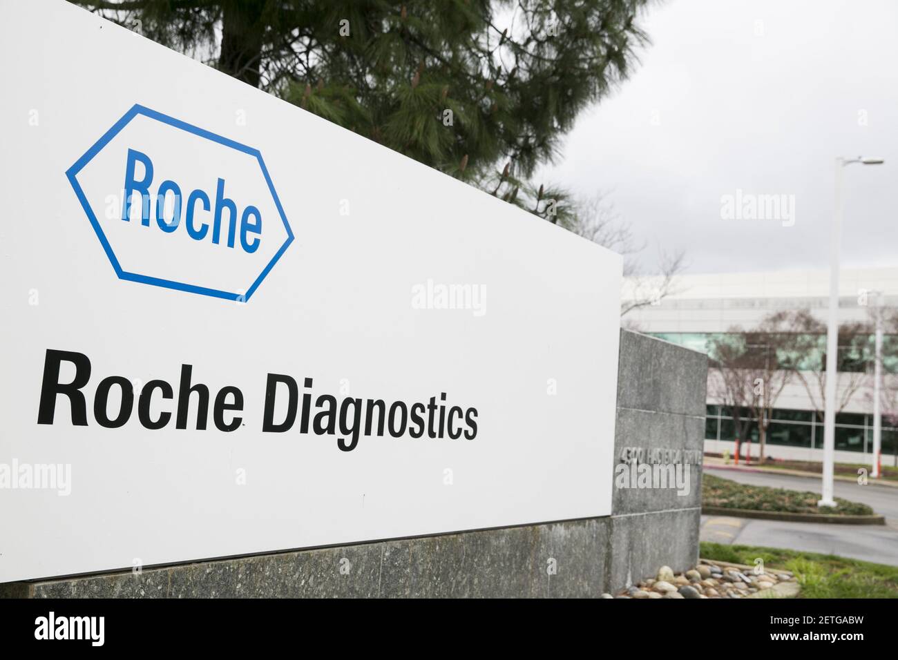 A logo sign outside of a facility occupied by Roche Diagnostics in ...