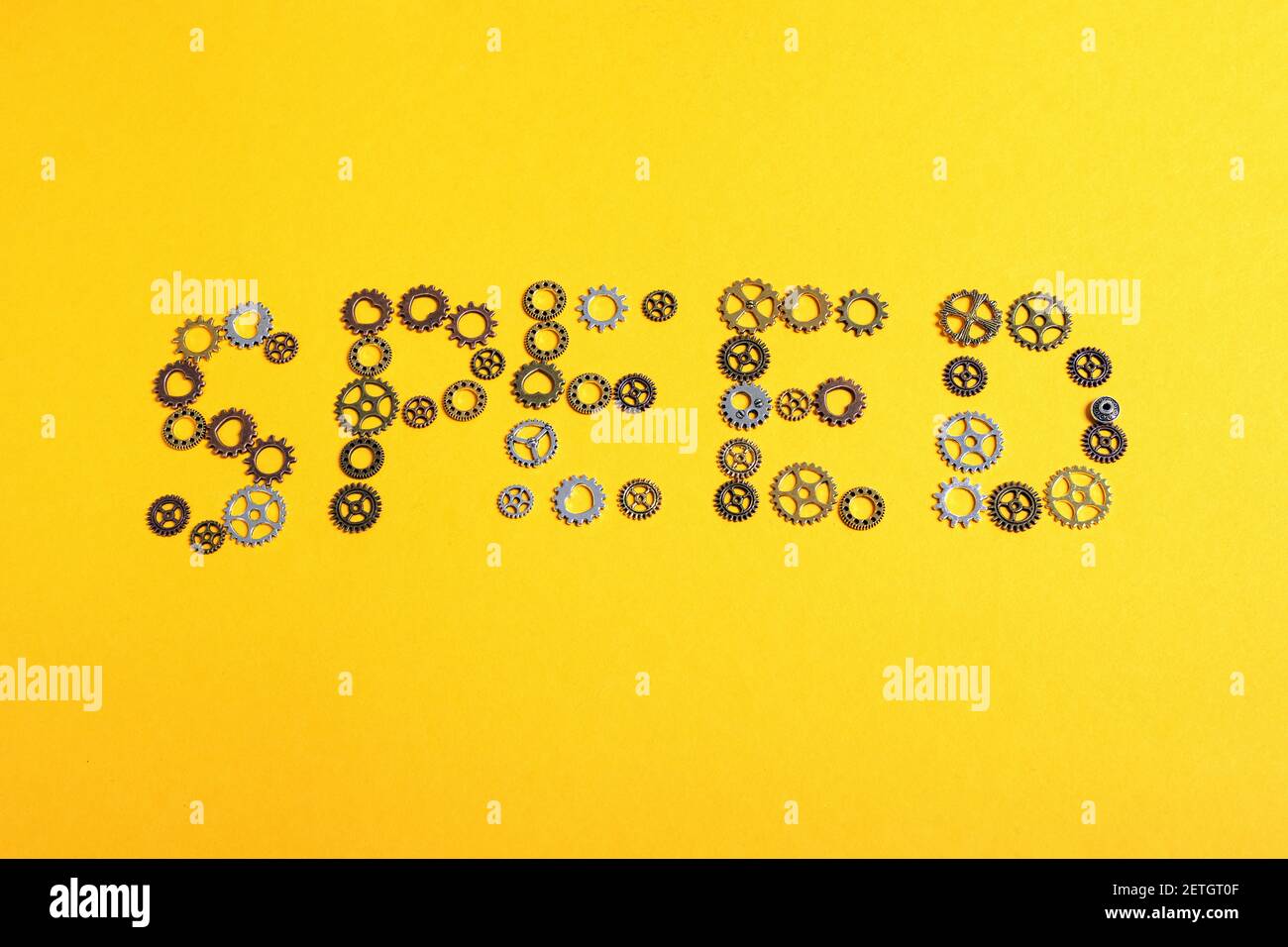 word speed made of gears on yellow background Stock Photo - Alamy
