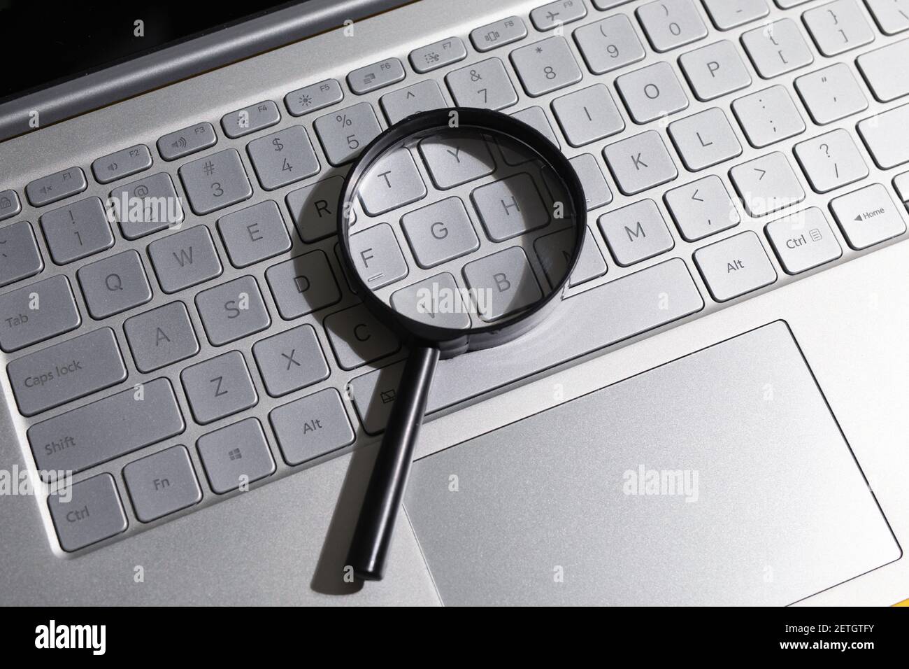 Magnifying glass on laptop computer keyboard. concept of search and web ...